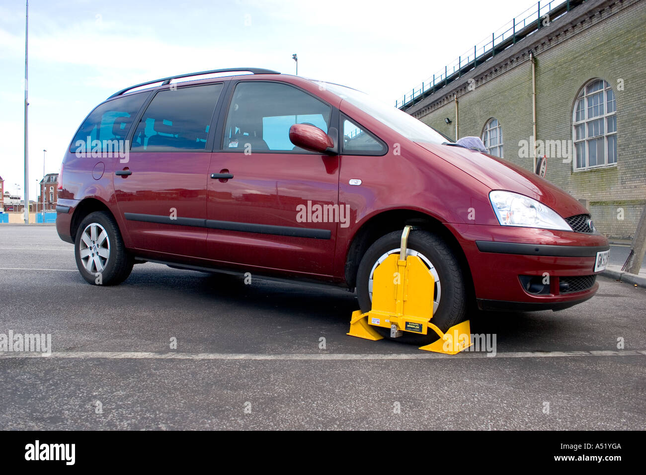 Car with wheel clamp on it Stock Photo - Alamy