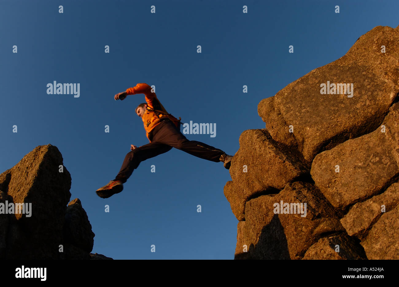 man jumping on tor granite rocks trail autumn dartmoor leaping chasm ...