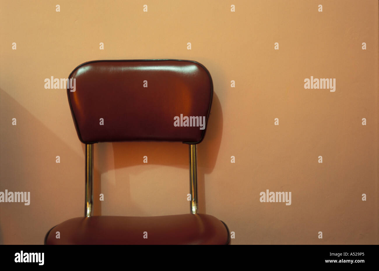Chair against the wall Stock Photo - Alamy