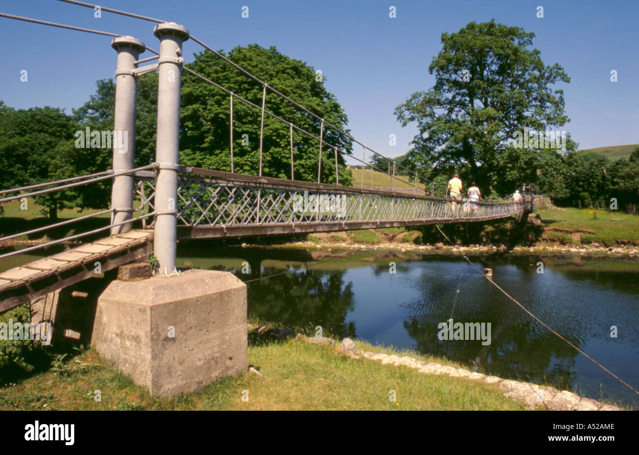 Simple suspension bridge over the River Wharfe, near Hebden, Wharfedale ...