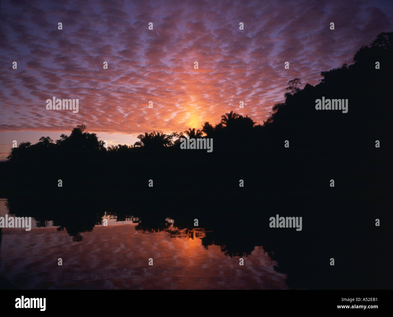A line of fishbone clouds catch the last of the sun over the Bolivian ...