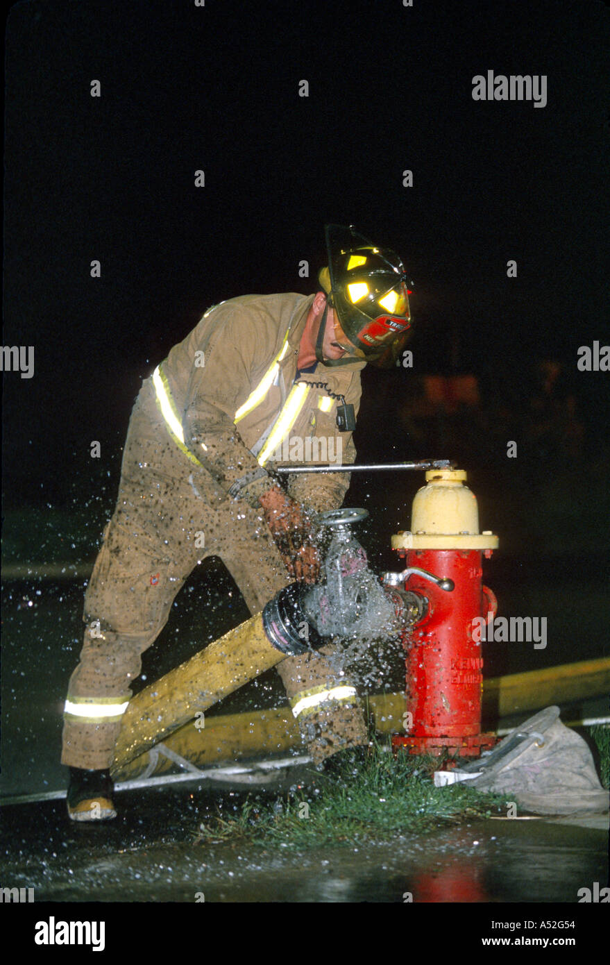 fireman firefighter at fire hydrant connection disconnecting hose ...