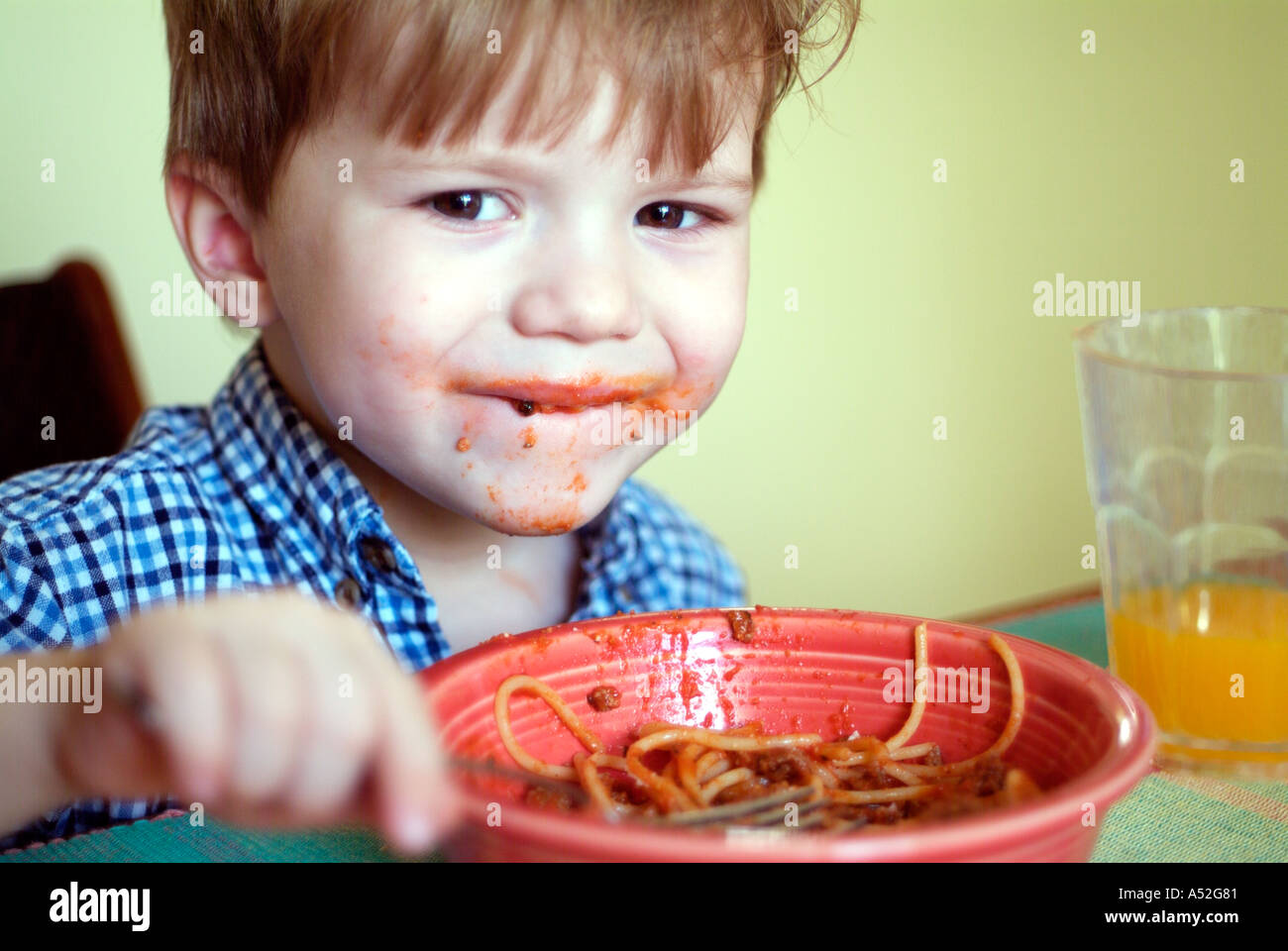 Boy eating messy spaghetti dinner from bowl young boy eating spaghetti ...