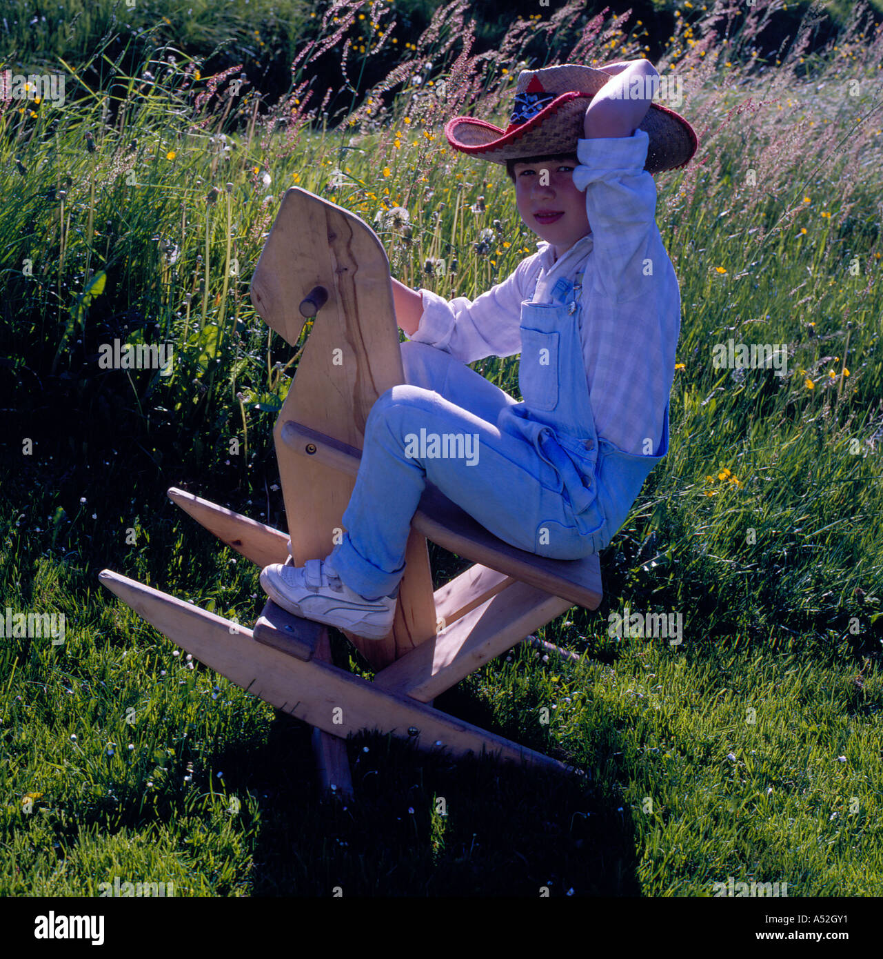 boy riding on a horselike rocking chair. Photo by Willy Matheisl Stock ...