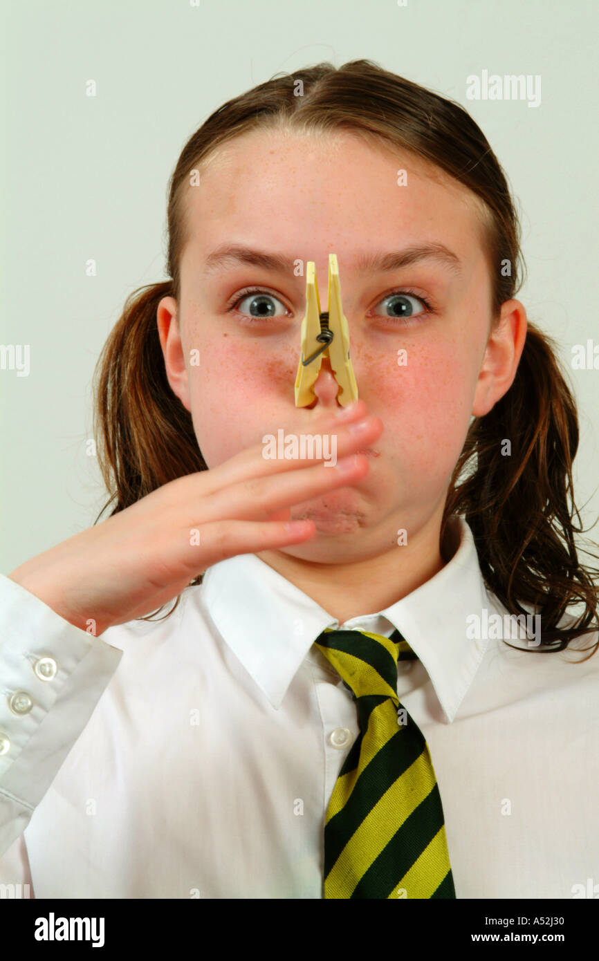 girl wafting hand with peg on her nose with a bad smell Stock Photo - Alamy