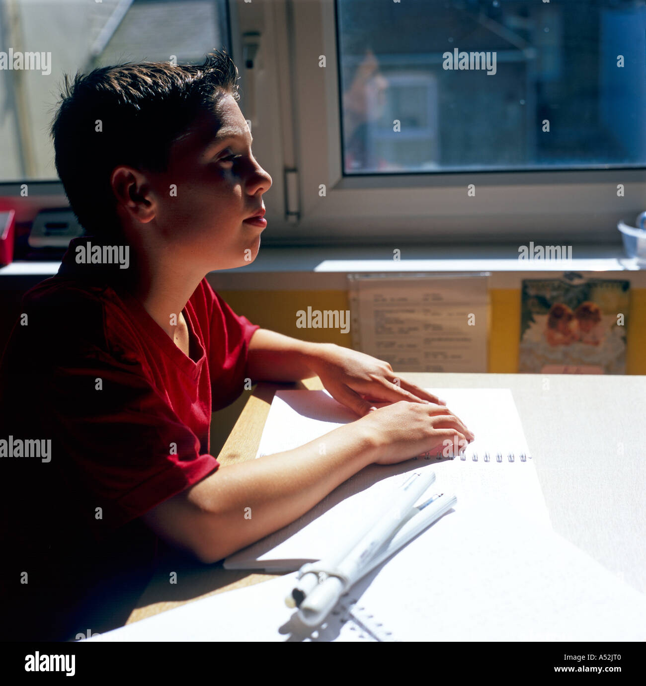 Blind Boy aged 12 years reading a Braille book Stock Photo - Alamy