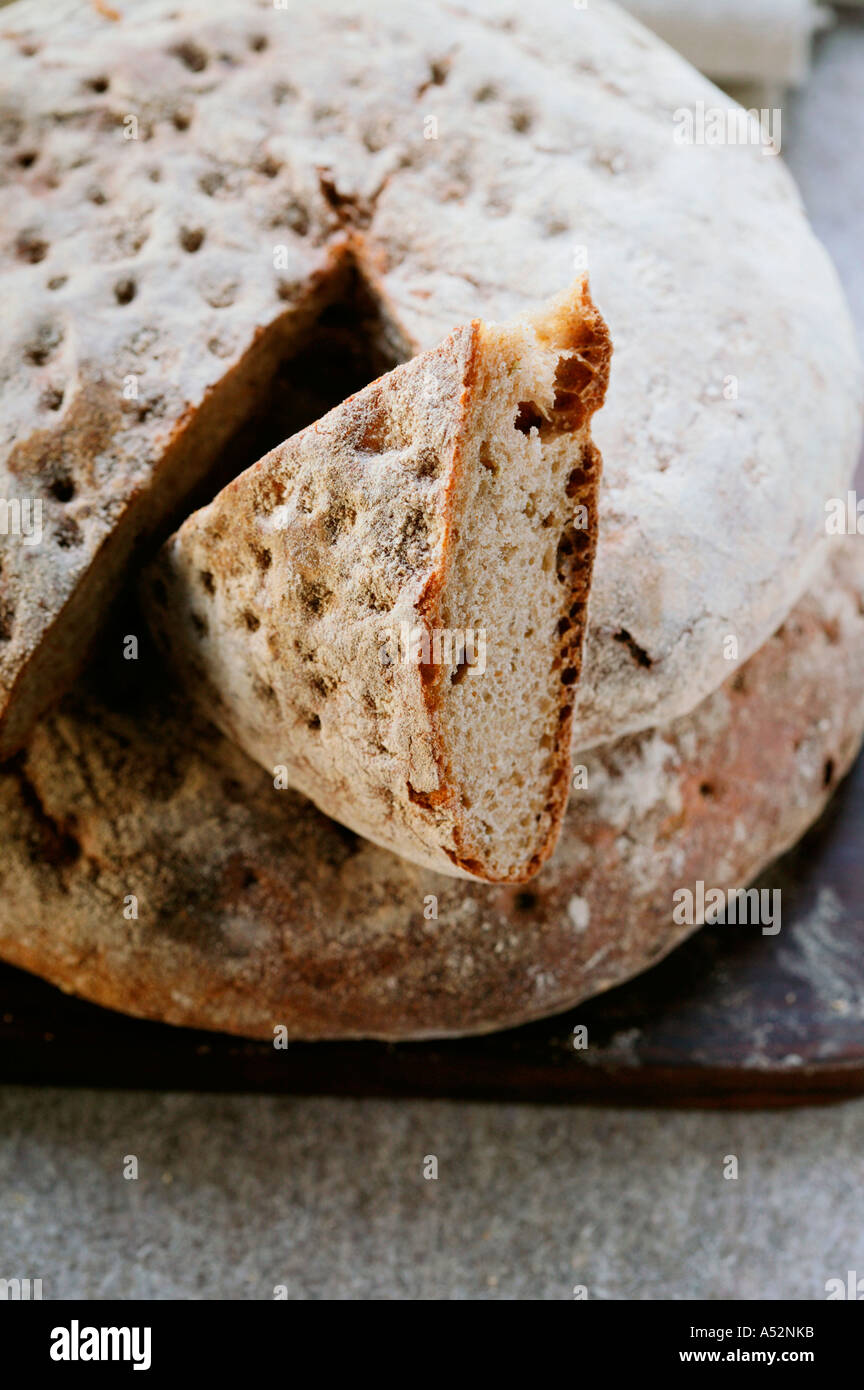 Rustic flatbreads with piece cut out Stock Photo - Alamy