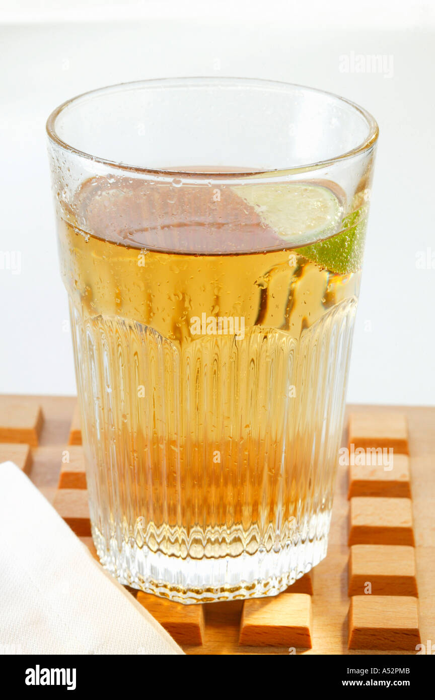 Apple juice with wedge of lime in glass Stock Photo - Alamy