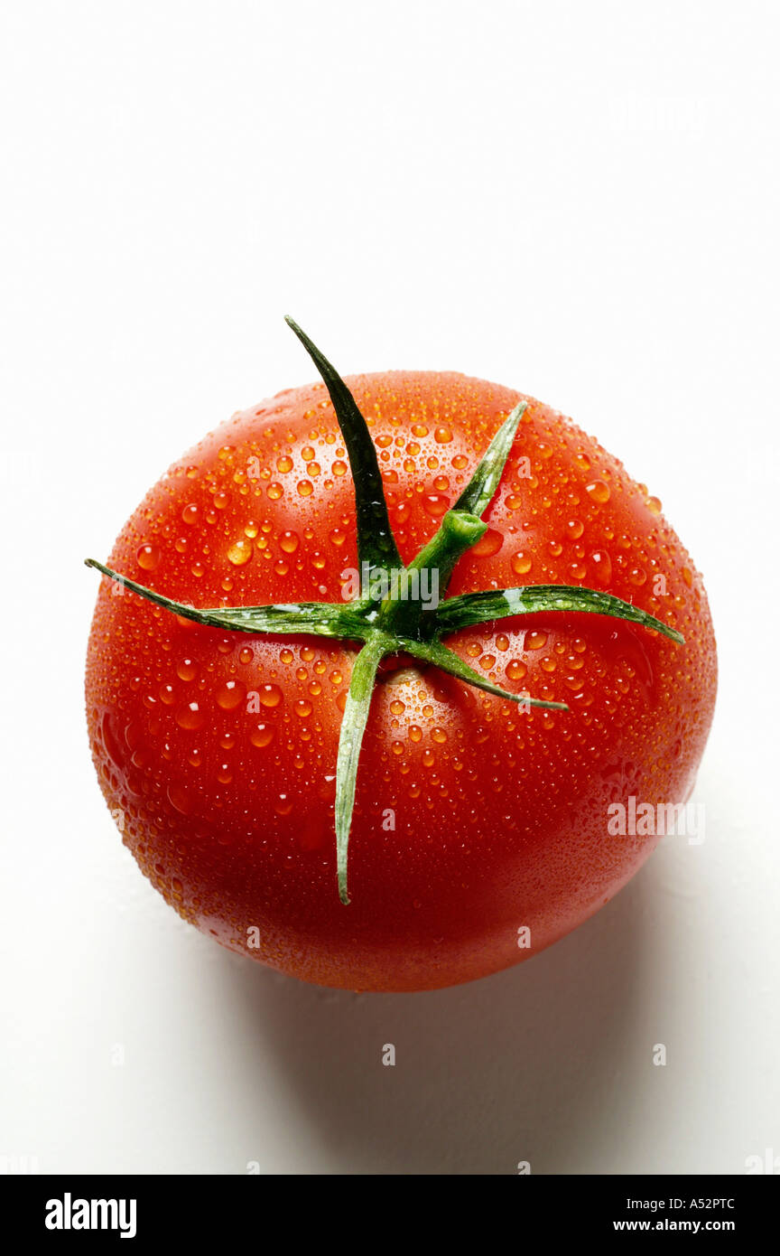 Tomato with drops of water from above Stock Photo - Alamy