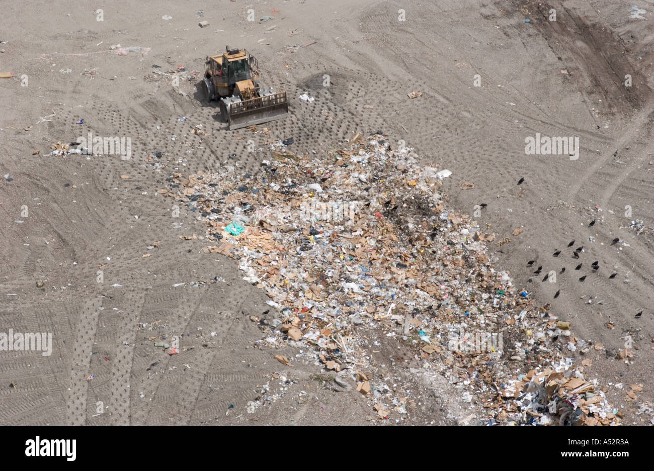 bulldozer moving and compressing garbage at landfill dump trash Stock ...