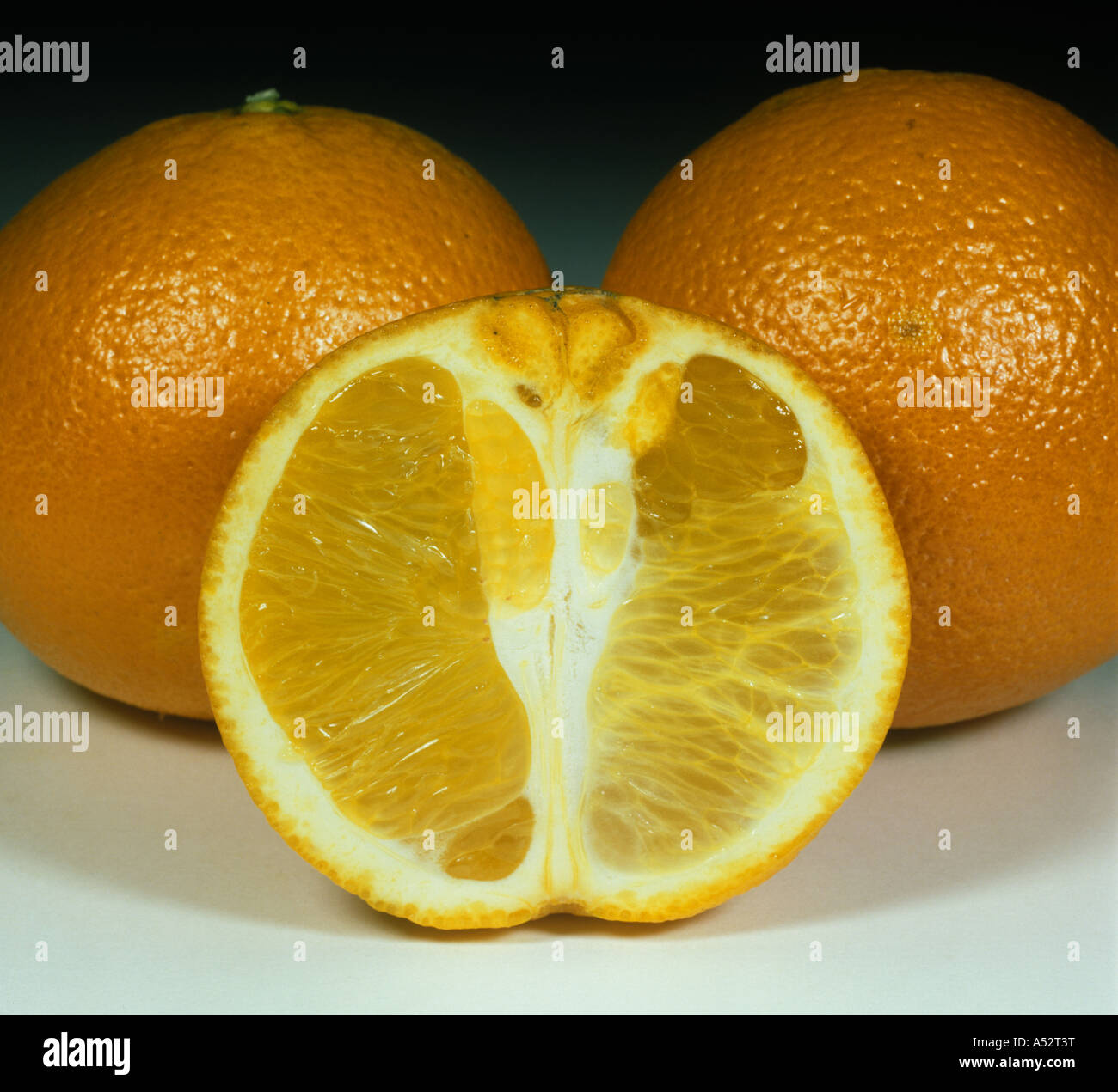 Whole & sectioned orange fruit variety Washington Navel cut to show ...
