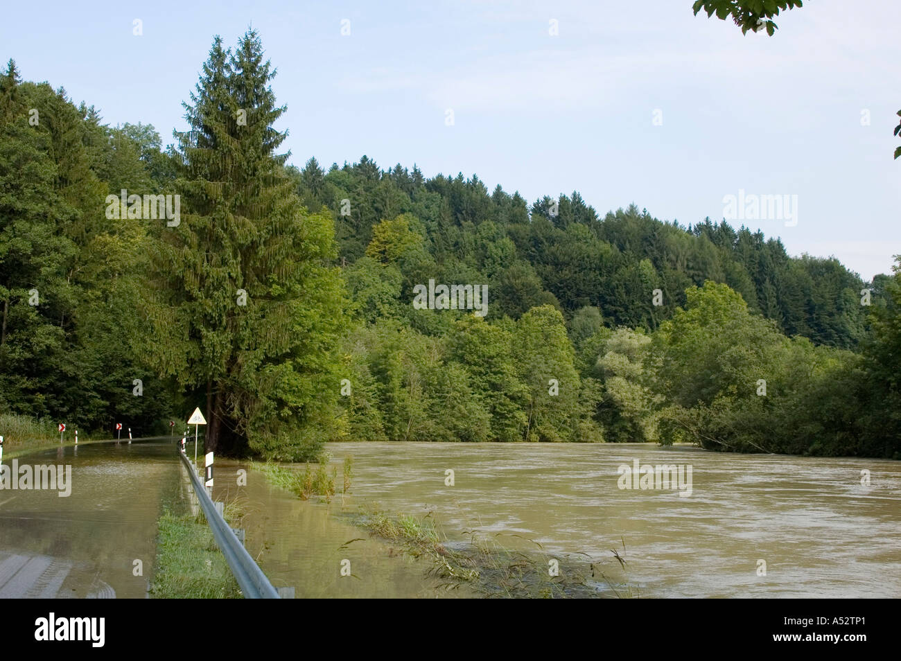 Flooding trees under water river floods street danger Stock Photo - Alamy