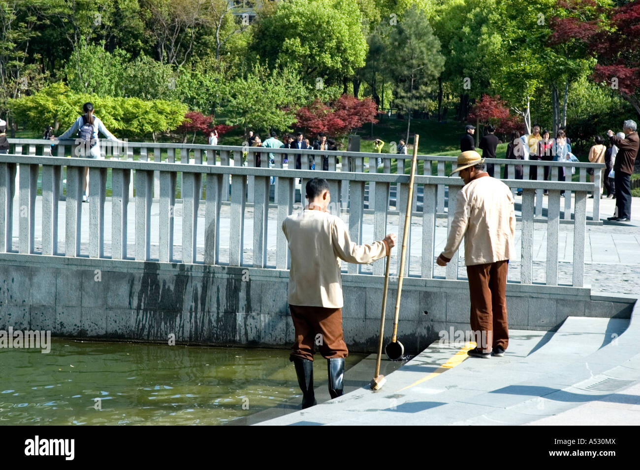 Chinese workers cleaning steps to the lake, Shanghai Stock Photo - Alamy