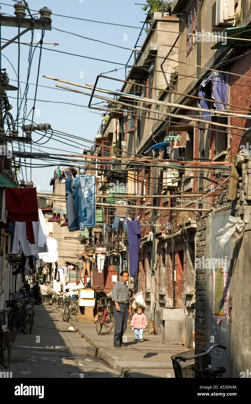 Cluttered alley alongside an apartment block, Shanghai Stock Photo - Alamy