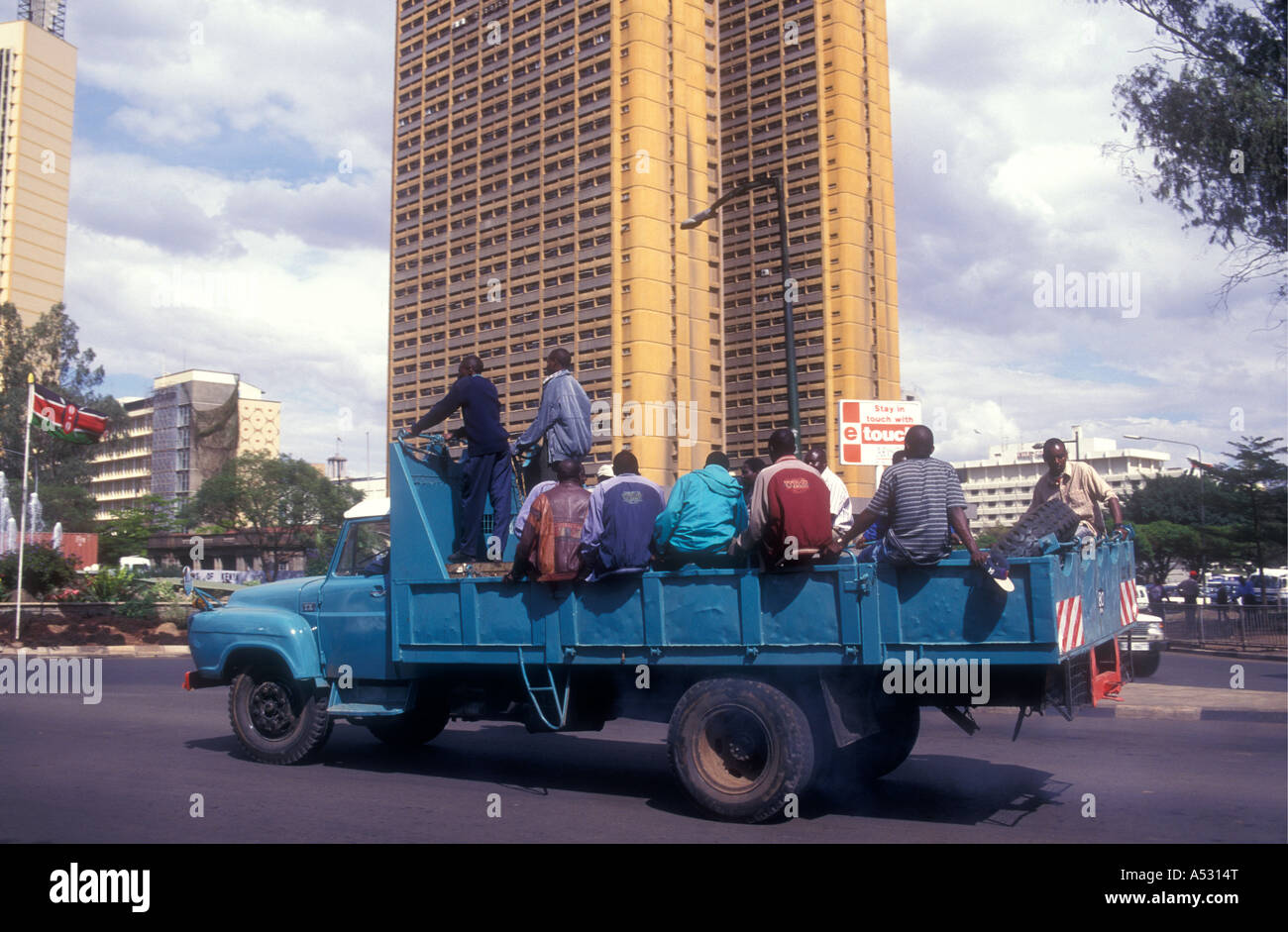 Workmen riding on the back of a lorry on their way to work Nairobi ...