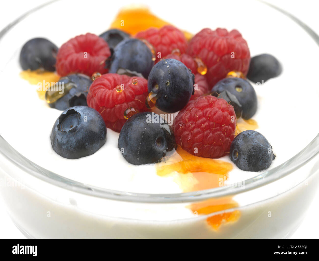 Natural Yoghurt with Blueberries Raspberries and Honey Stock Photo - Alamy