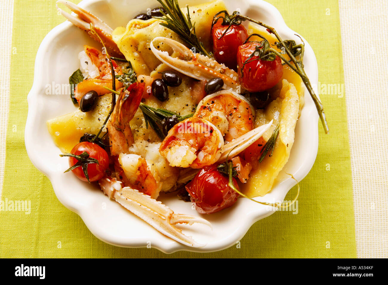 Ravioli with scampi tomatoes and olives Stock Photo - Alamy
