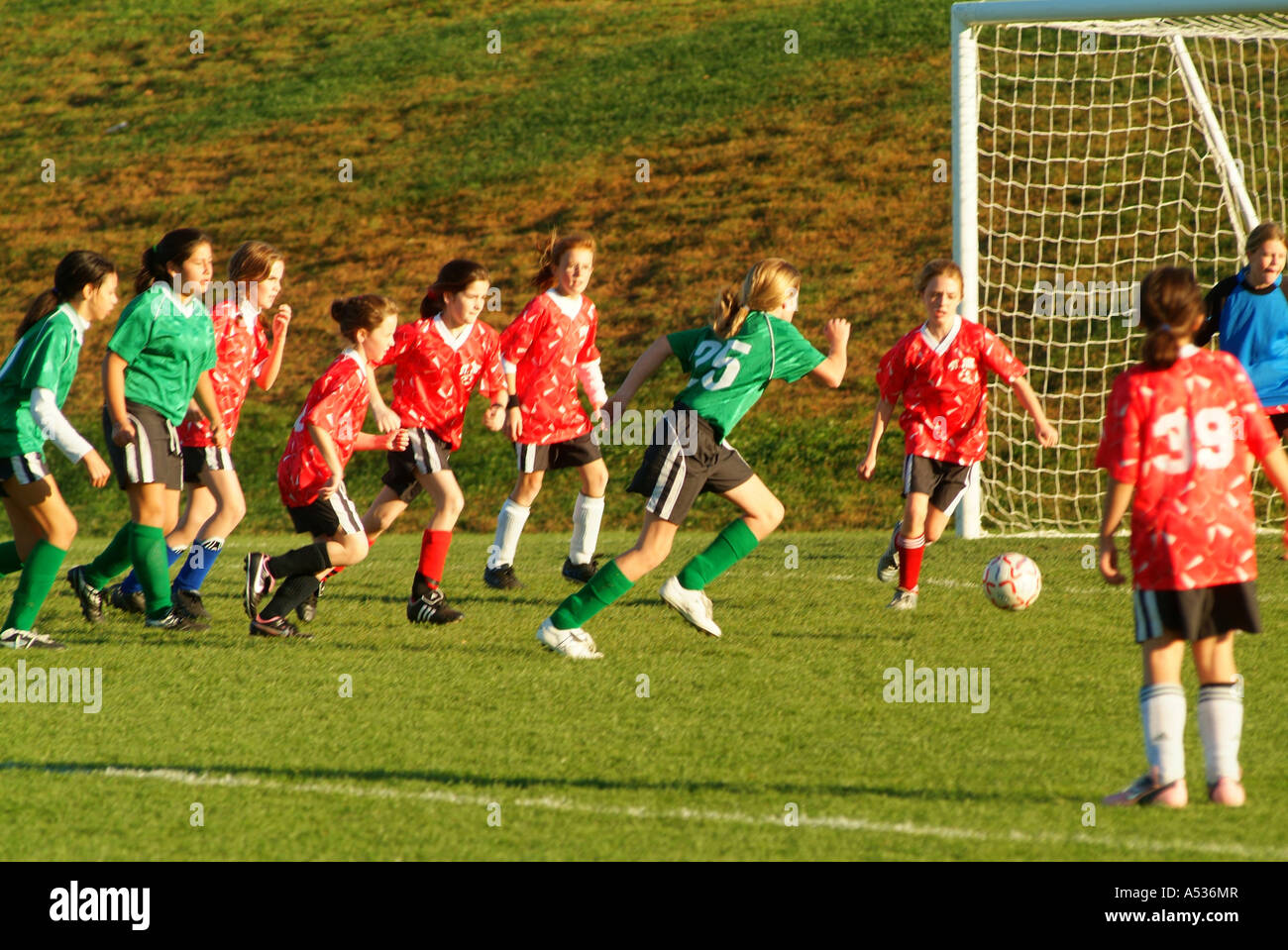 Junior Varsity middle school girls play soccer on a soccer park field ...
