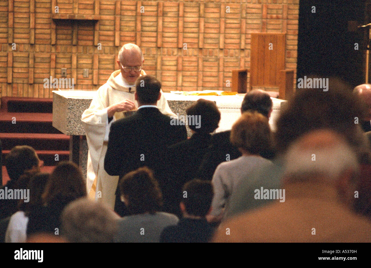 Catholic priest performing communion. St. Alphonsus Catholic Church ...