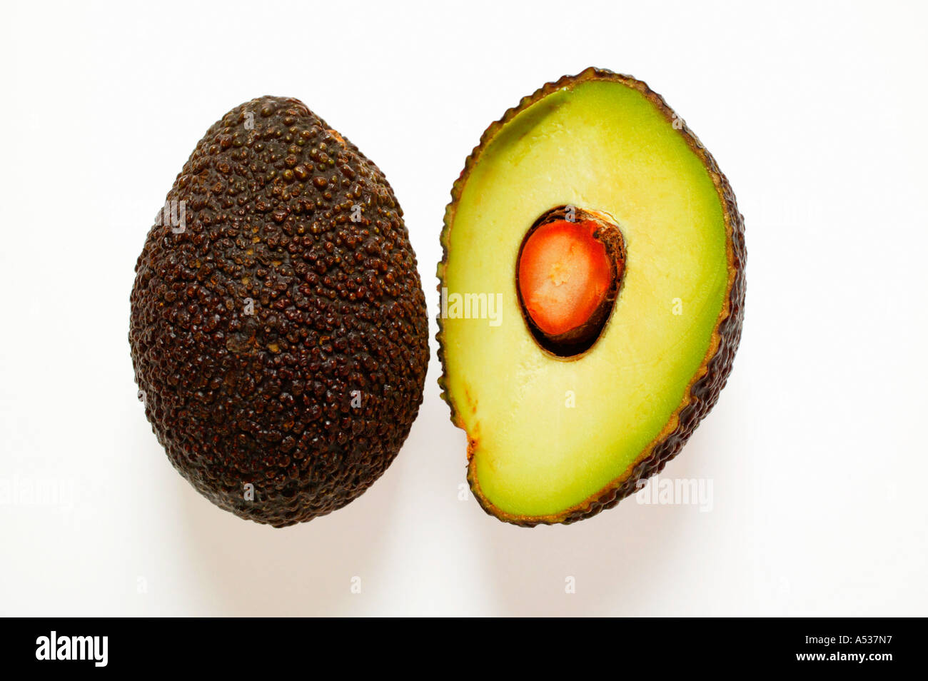 Whole and half mini avocado Stock Photo - Alamy