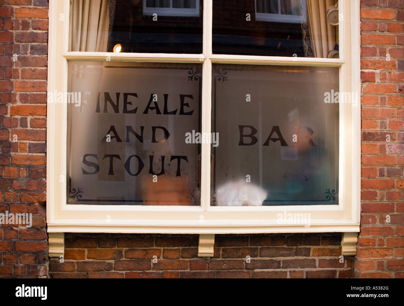 A pub window with frosted sign saying Fine Ale and Stout Bar Stock ...