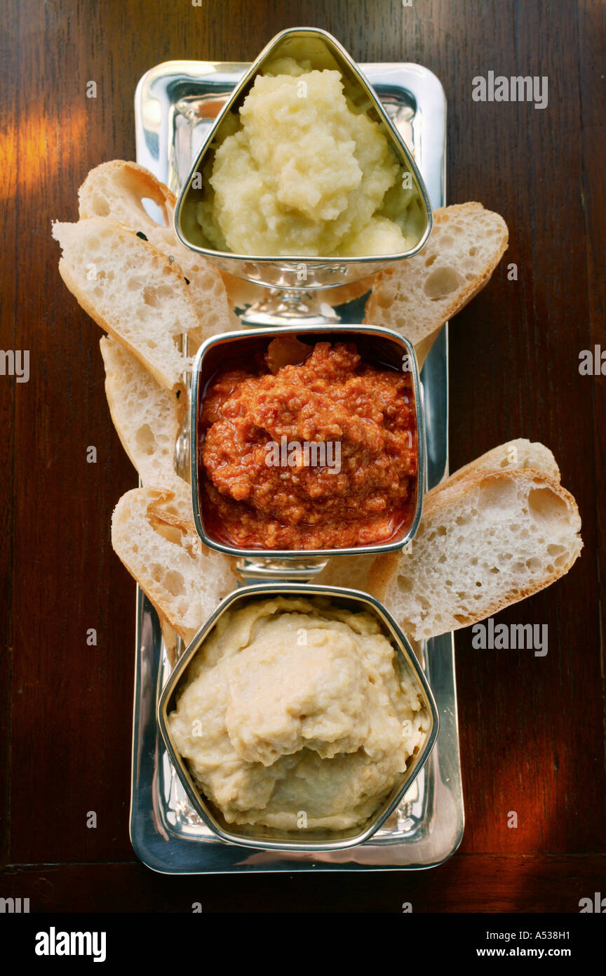 Three spicy dips with white bread Stock Photo - Alamy