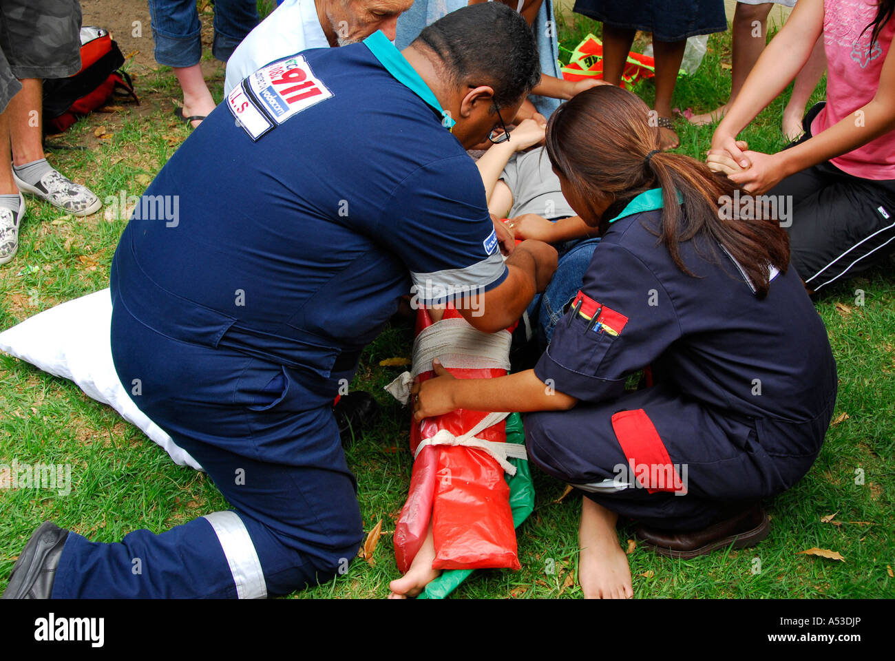 Paramedics helping patient with leg injury to be taken to hospital by ...