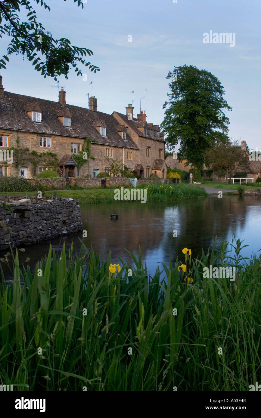 Quaint limestone cottages alongside the river eye at Lower Slaughter in ...