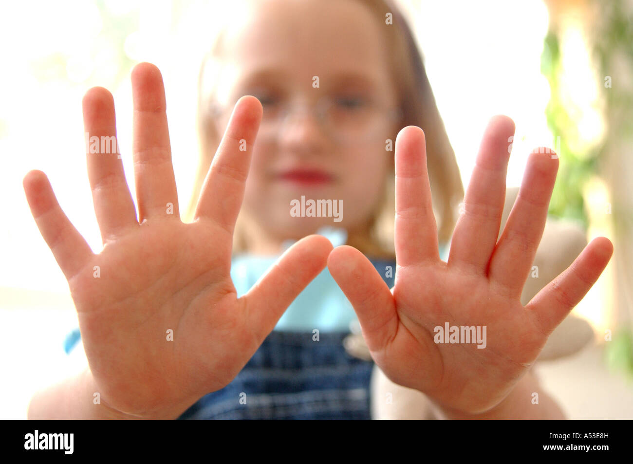 Portrait of British girl having fun adding up with her fingers in ...
