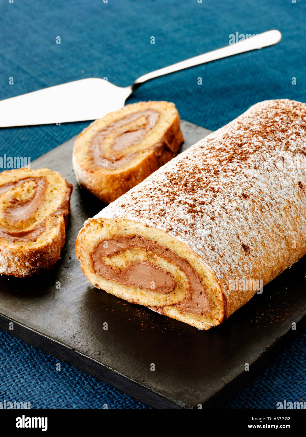 Sponge roll with chocolate cream Stock Photo - Alamy