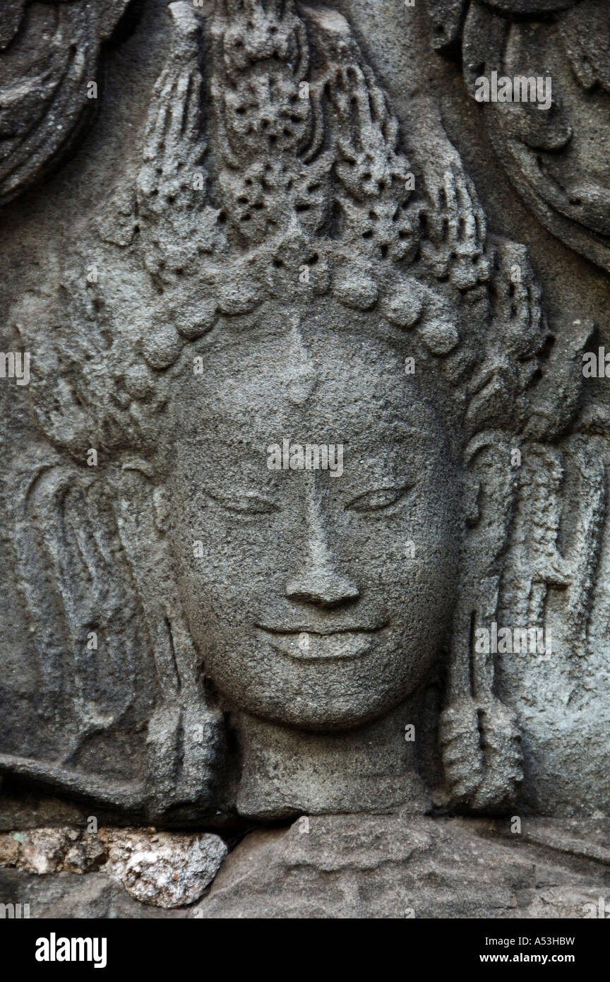 Stone carving of a female face Apsaras standing celestial nymphs Bayon ...