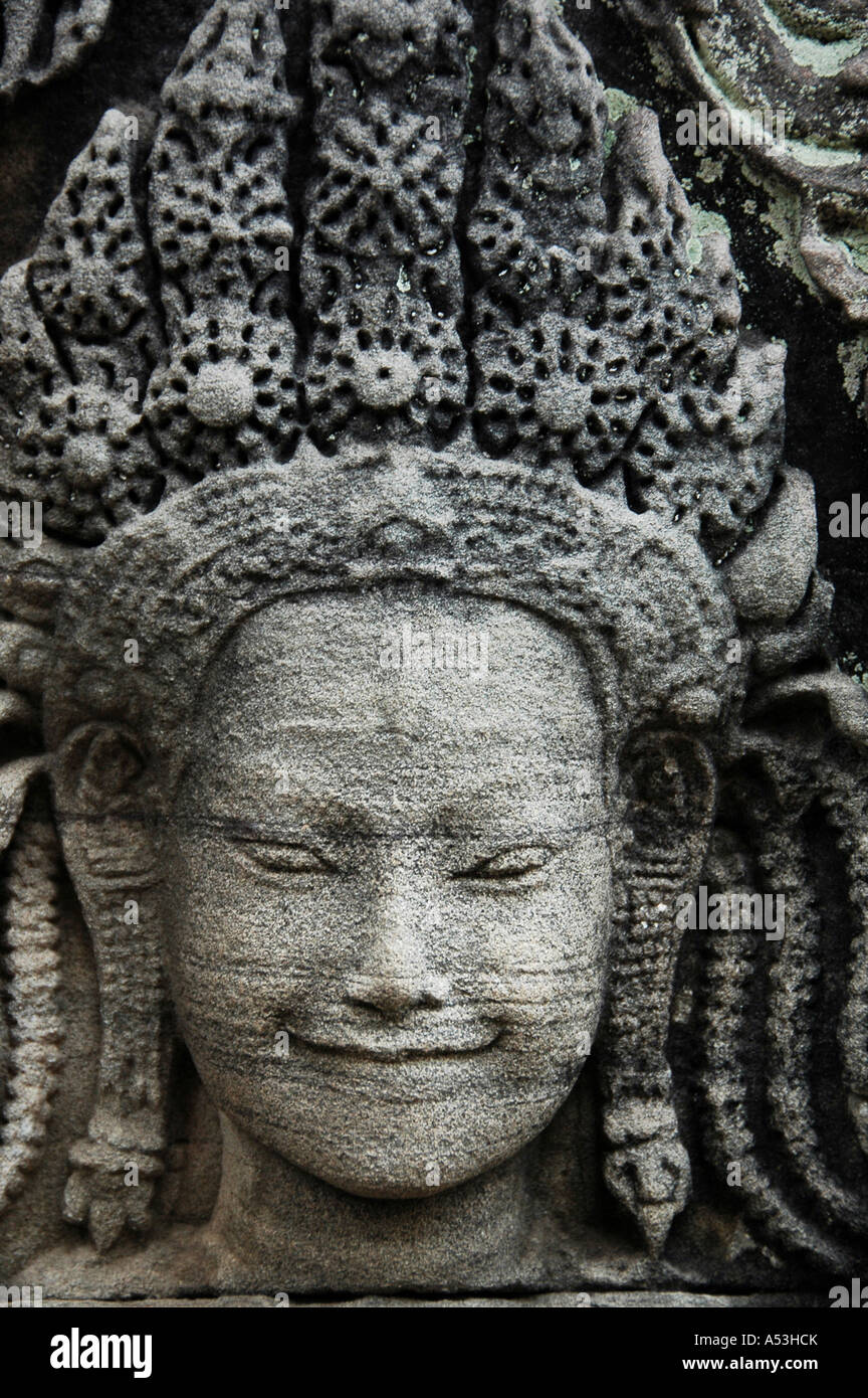 Stone carving of a female face Apsaras standing celestial nymphs Bayon ...