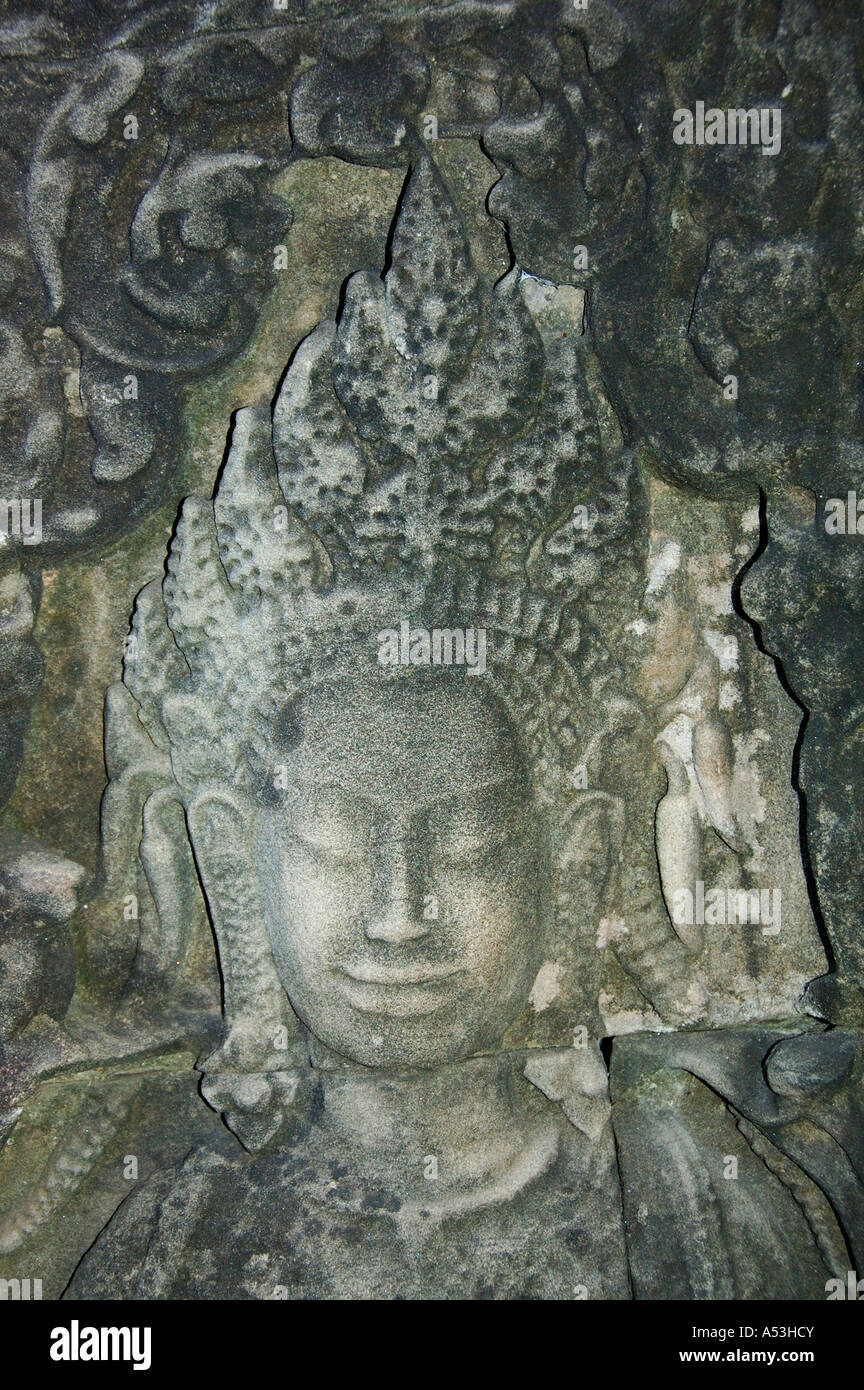 Stone carving of a female face Apsaras standing celestial nymphs Bayon ...
