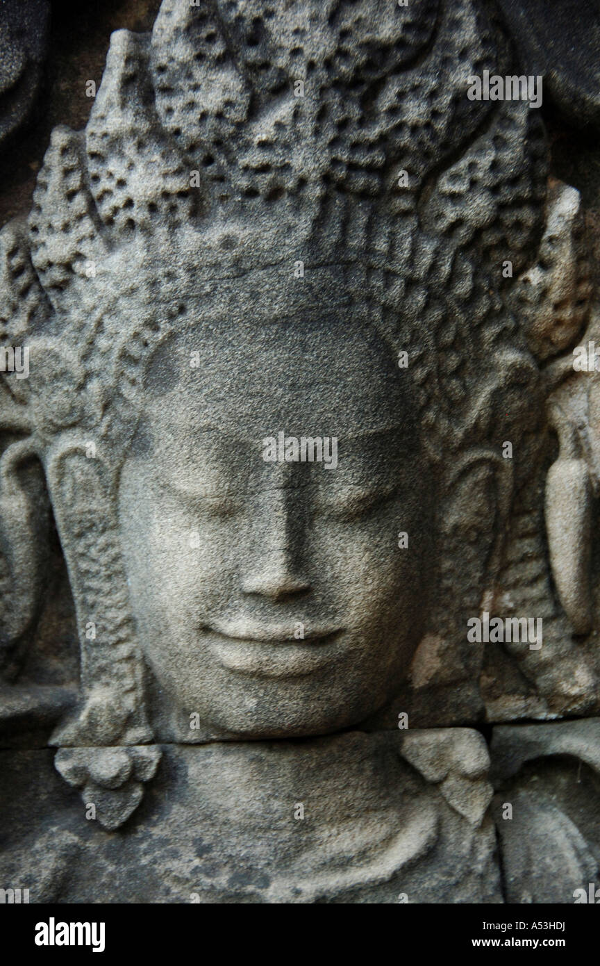 Stone carving of a female face Apsaras standing celestial nymphs Bayon ...