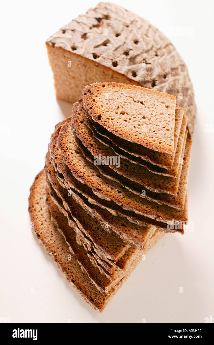 A quarter of a farmhouse loaf and slices of bread in a pile Stock Photo ...