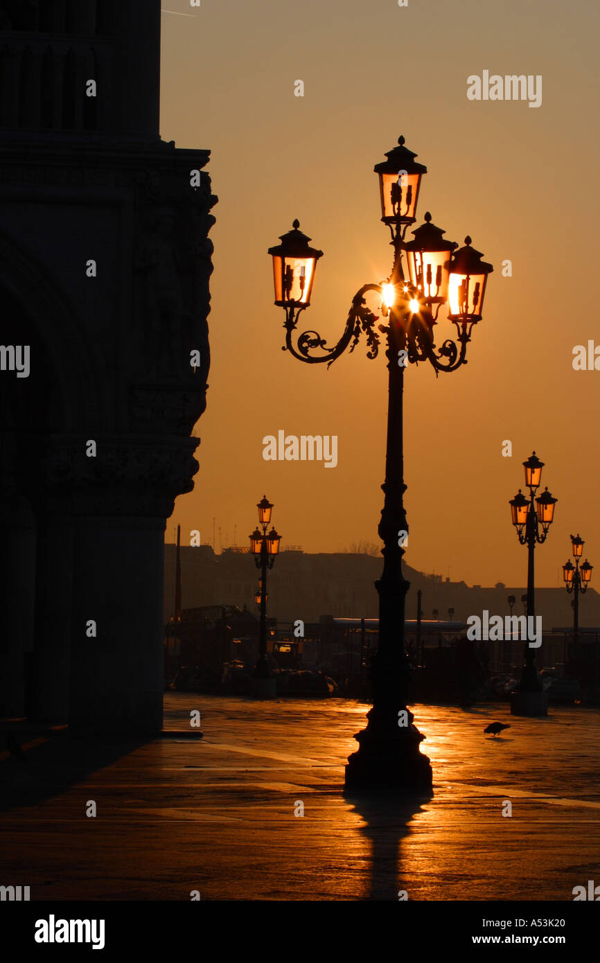 Lamp post next to the Doges Palace in St Marks Square at sunrise dawn ...