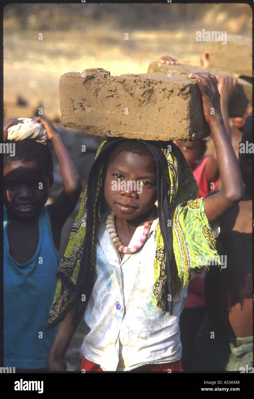 Painet ha1502 3032 color child labor carrying mud brick house ...