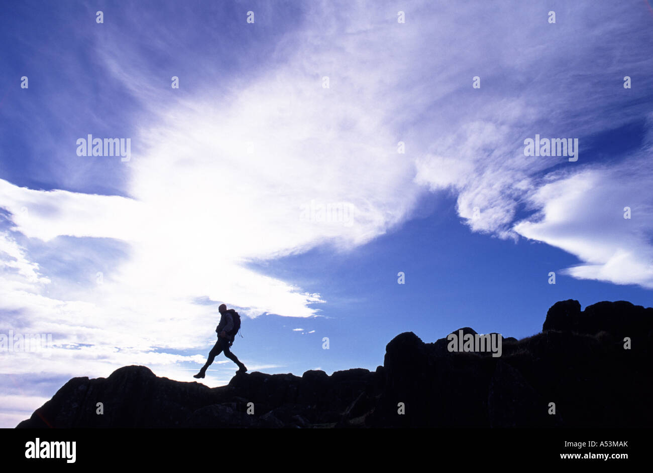 A walker on the summit of Bowfell in the Lake District Stock Photo - Alamy