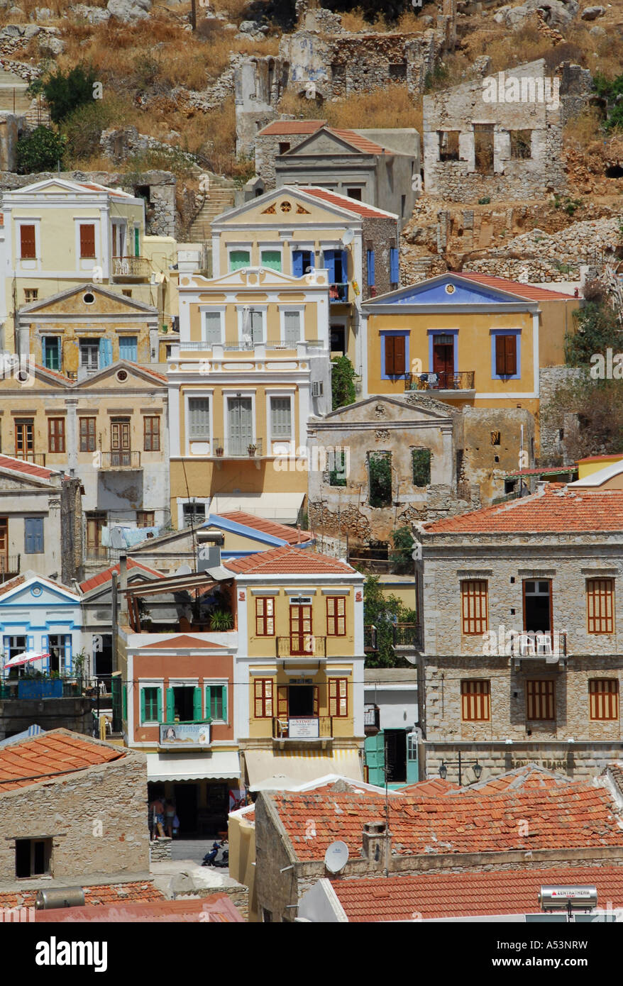 Neo-Classical houses on the hillside above Yialos harbour in Symi Town ...