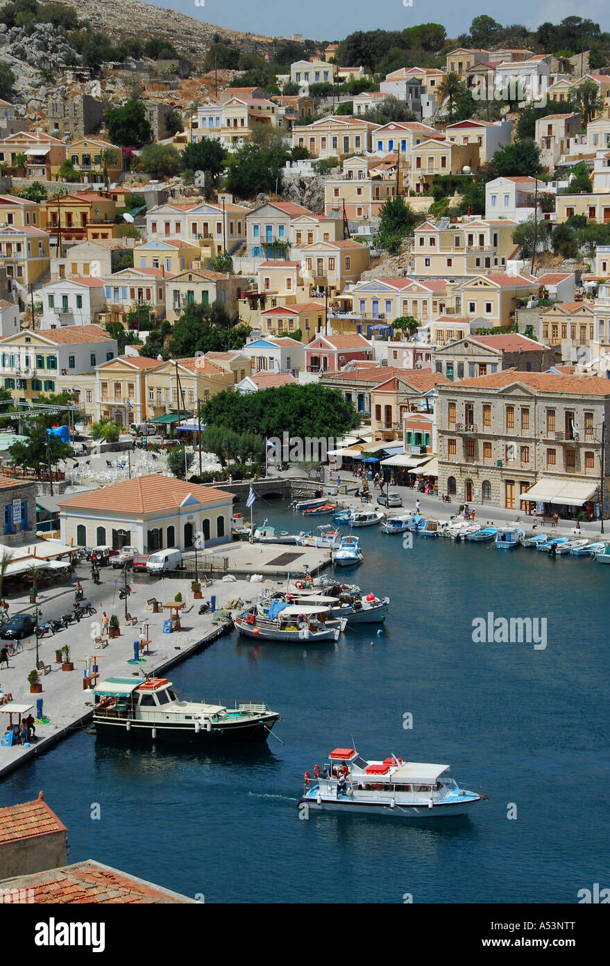 Neo-Classical houses on the hillside above Yialos harbour in Symi Town ...
