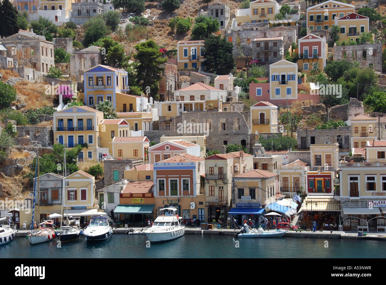 Neo-Classical houses on the hillside above Yialos harbour in Symi Town ...