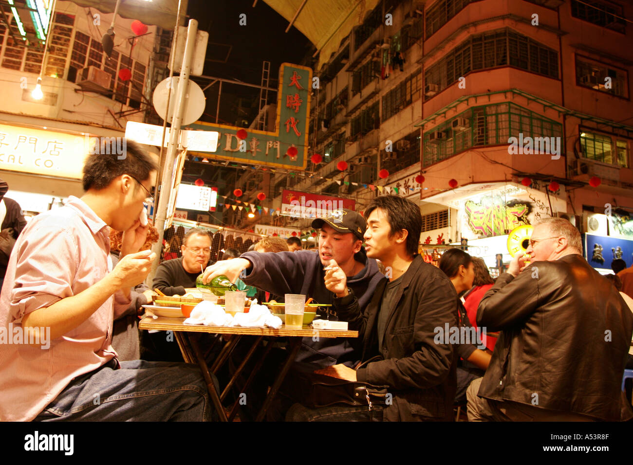 Chinese people eating at an outdoor restaurant in Hong Kong Stock Photo ...