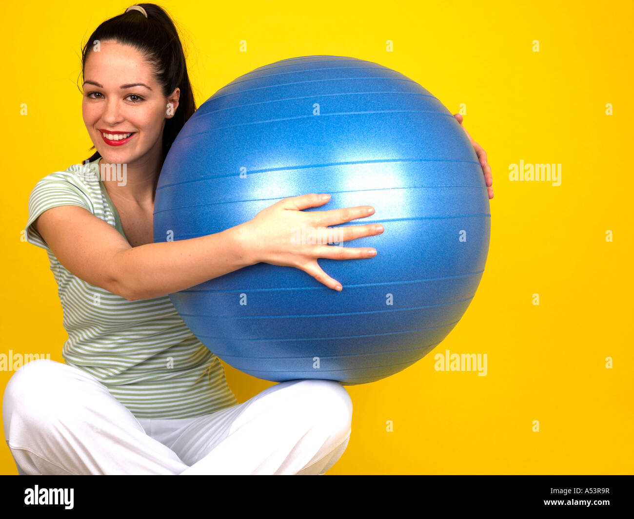 Woman hugging exercise ball hi-res stock photography and images - Alamy