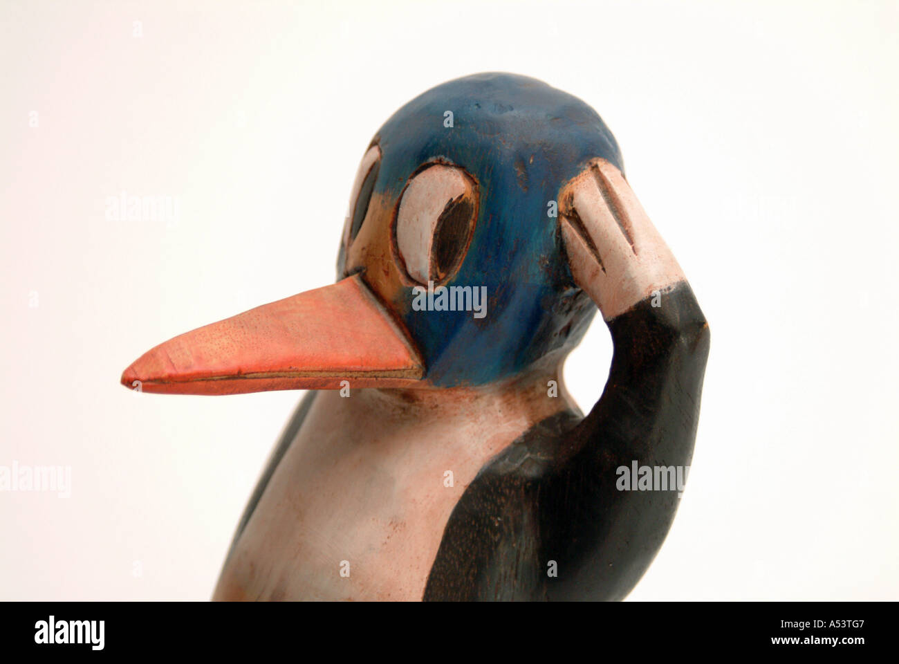 Penguin carved wood figure standing to attention salute Stock Photo - Alamy