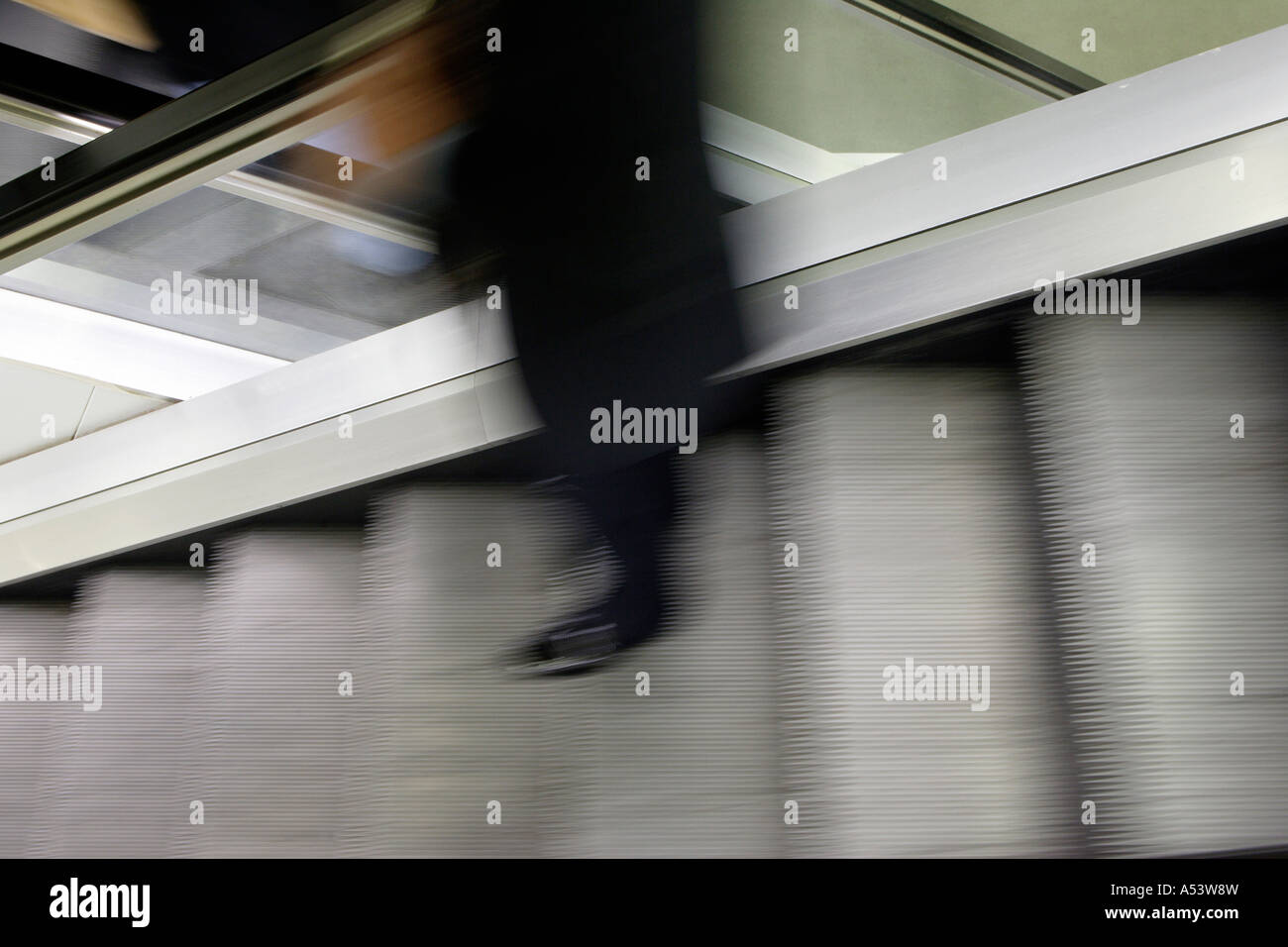 Human on an escalator Stock Photo - Alamy