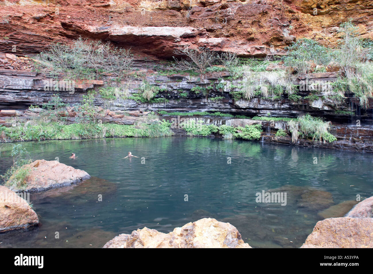 Two tourists swim in Circular Pool Dales Gorge Karijini National Park ...