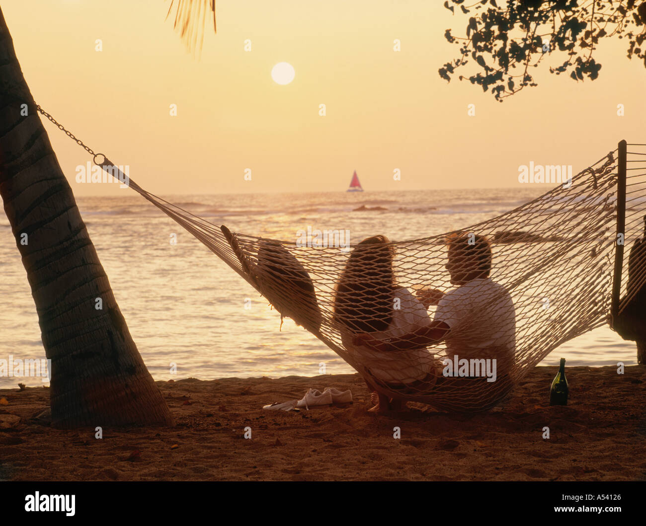 Couple sitting in hammock sunset hi-res stock photography and images ...