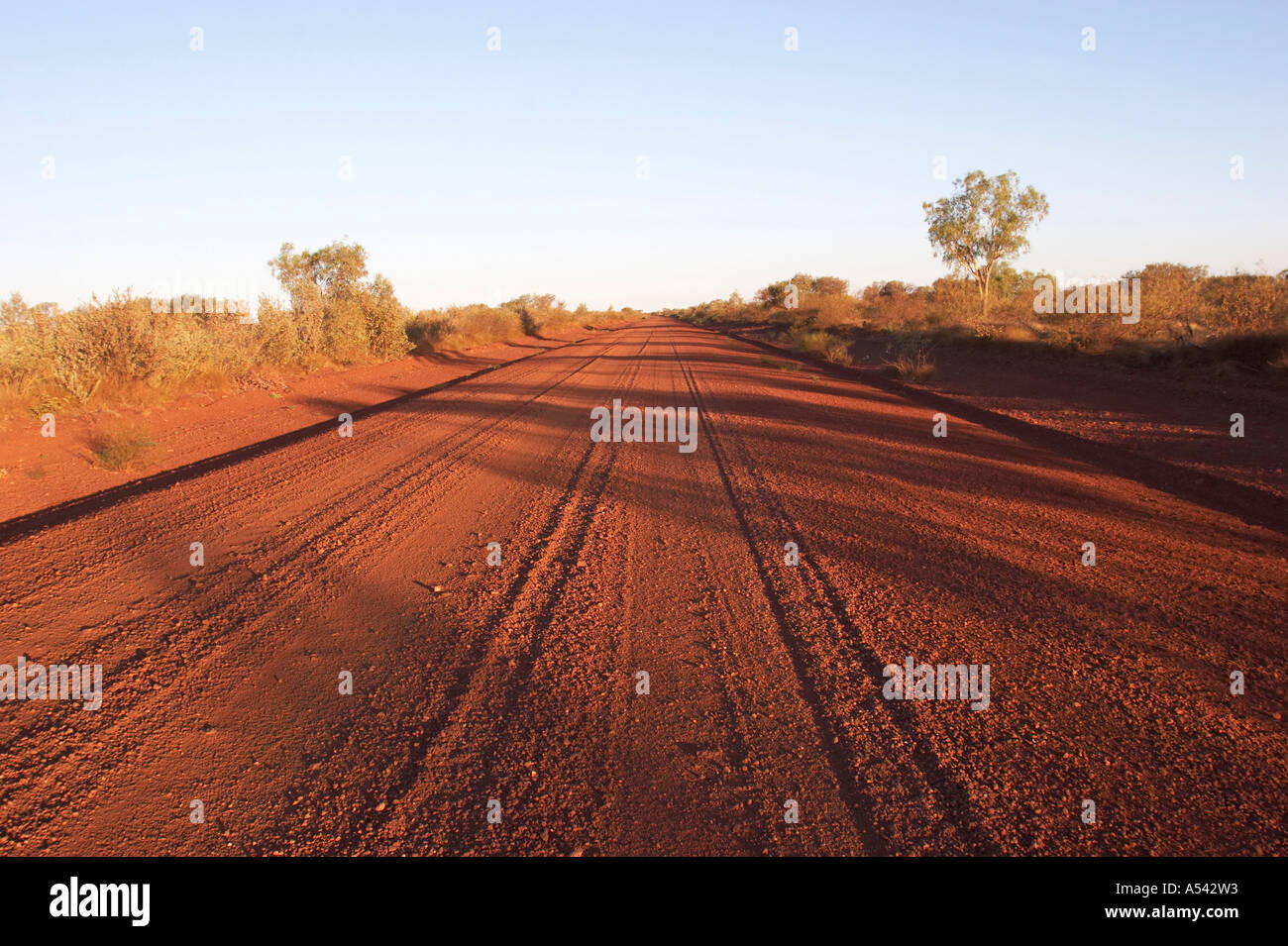 Straight gravel road in Pilbara outback at sunset western australia WA ...