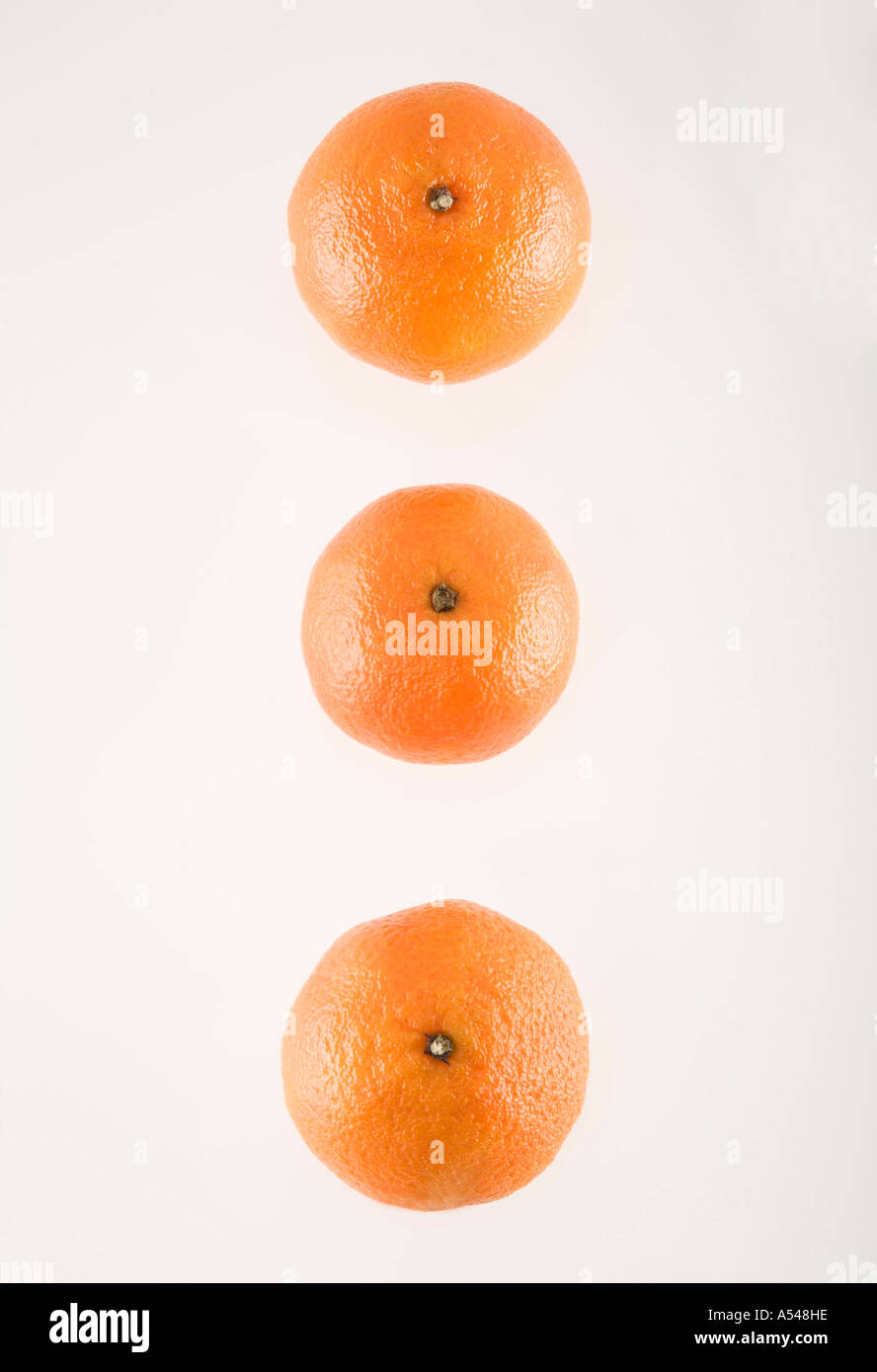 3 three tangerines in front of white Stock Photo - Alamy