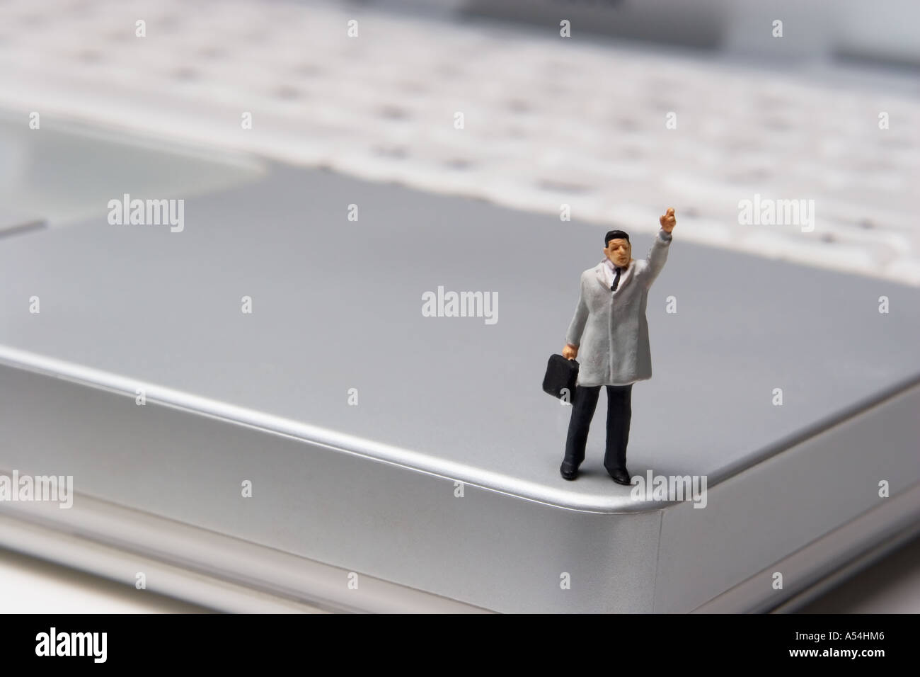 Business figurine placed on a laptop computer Stock Photo - Alamy